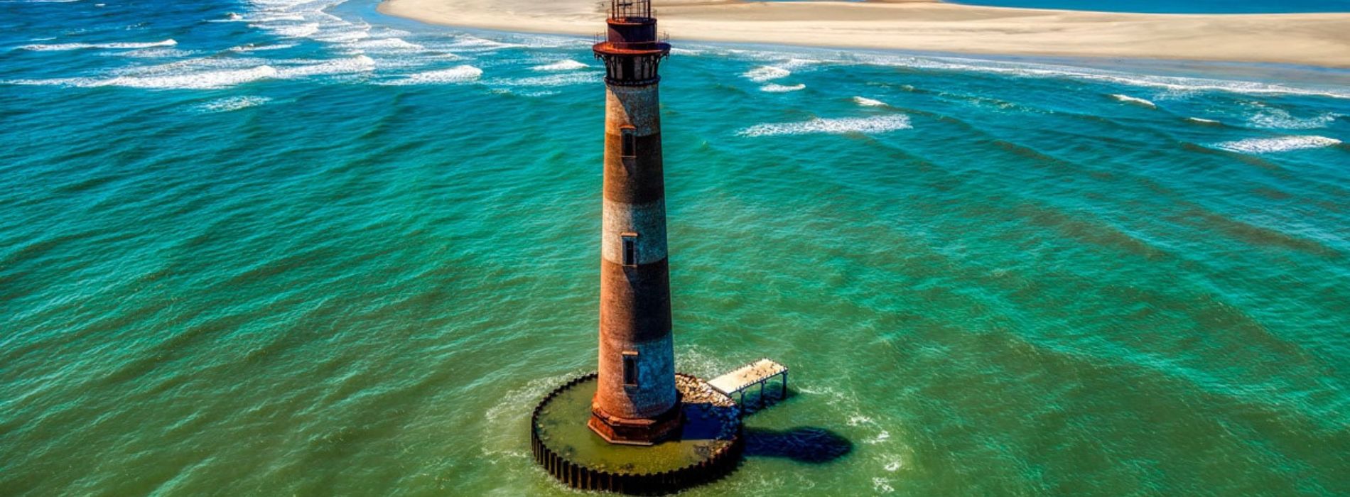 A lighthouse is located on a small island